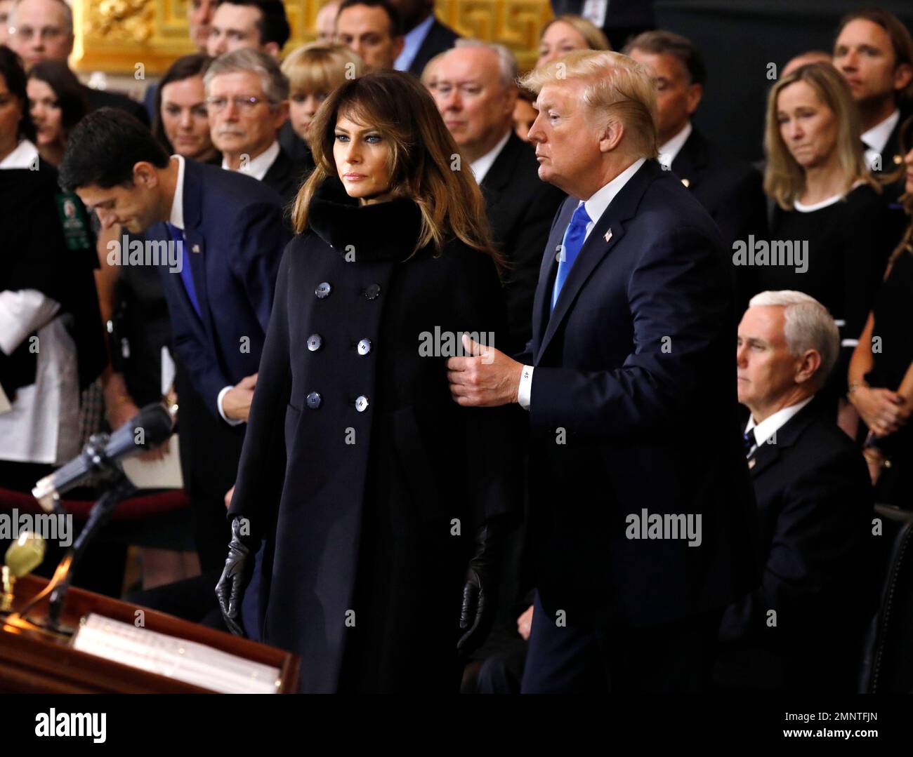 President Donald Trump and First Lady Melania Trump approach the casket ...