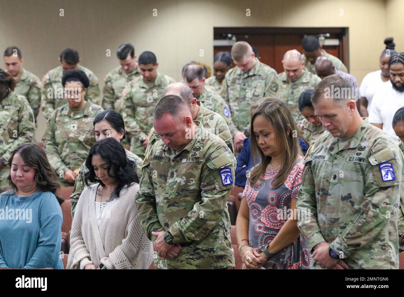 Command Sgt. Maj. Eric W. Cherry and family bow their heads in prayer ...