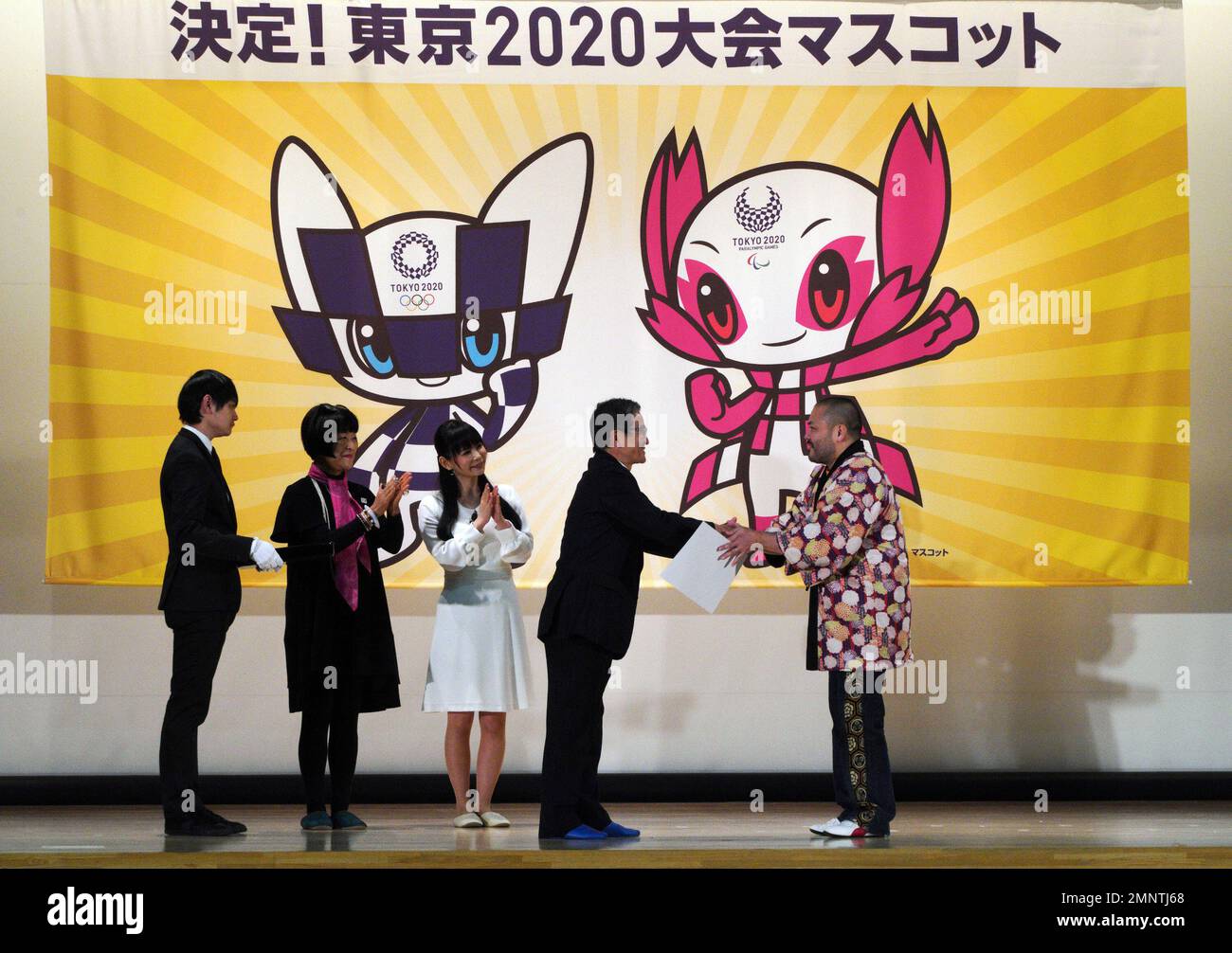 Ryo Taniguchi, the designer of the characters, shown in the background ...
