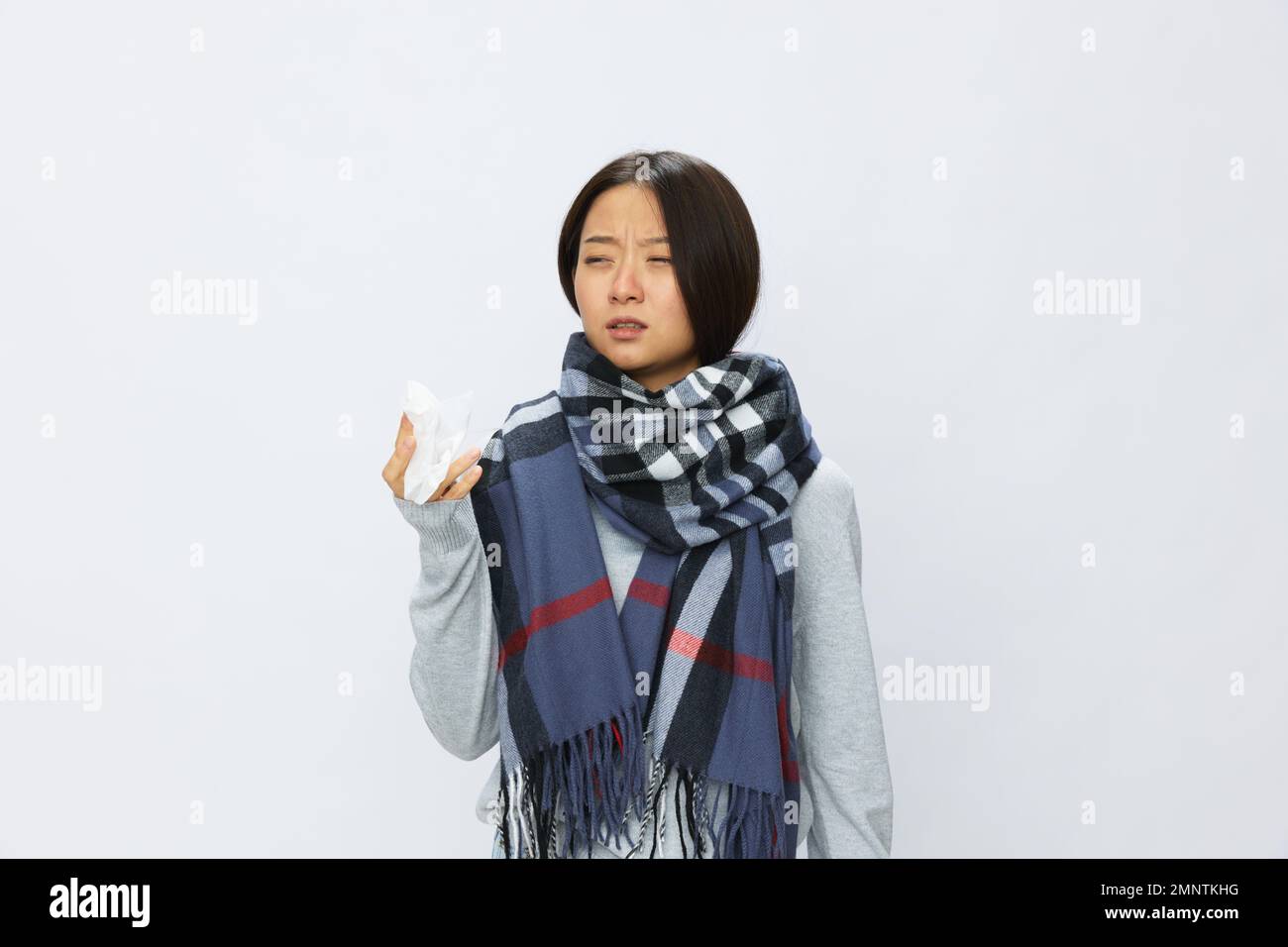 Asian woman cold flu holding handkerchief stuffed nose and coughing ...