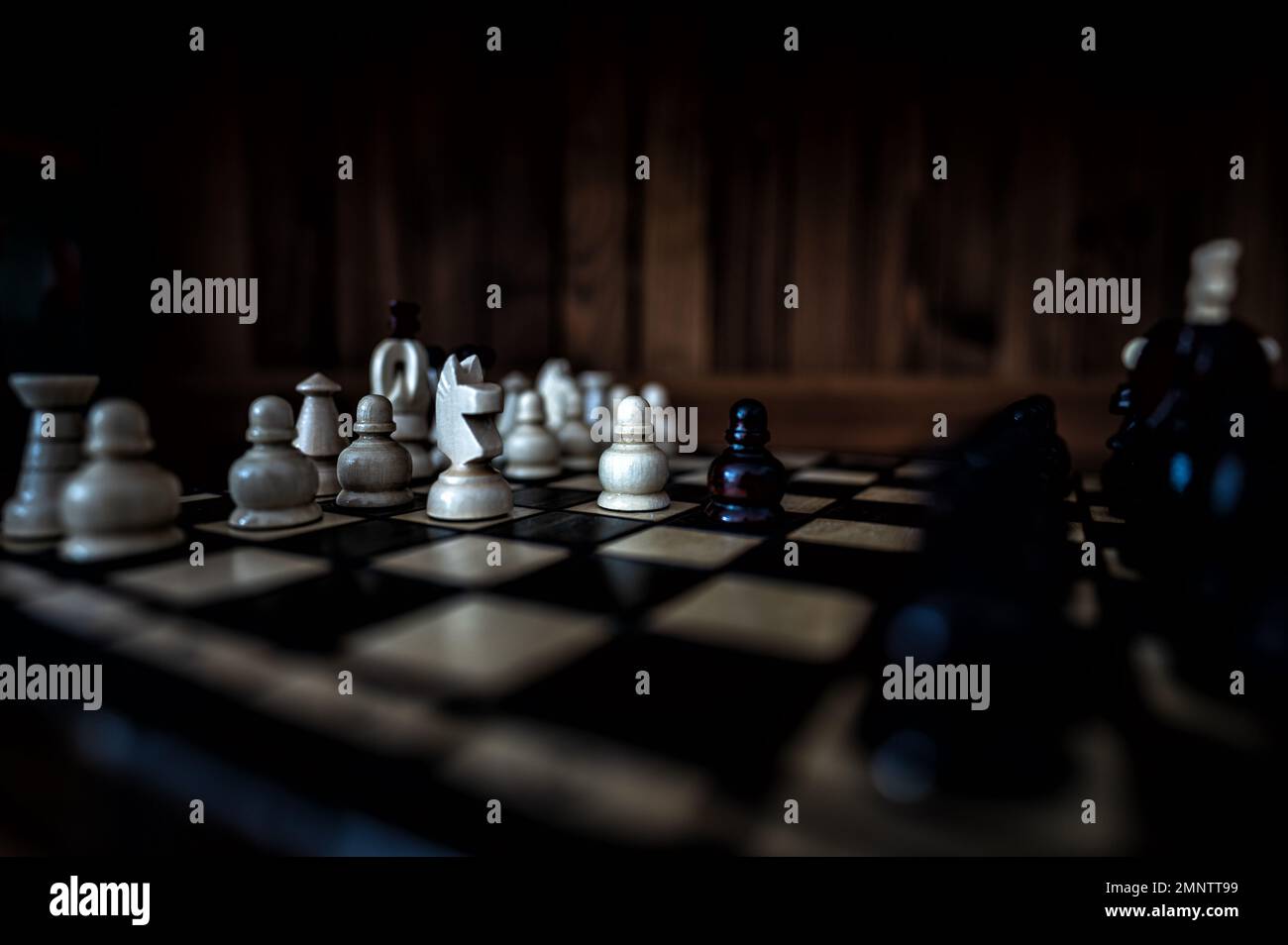 Blurred background with a low depth of focus. The set of wooden chess ...