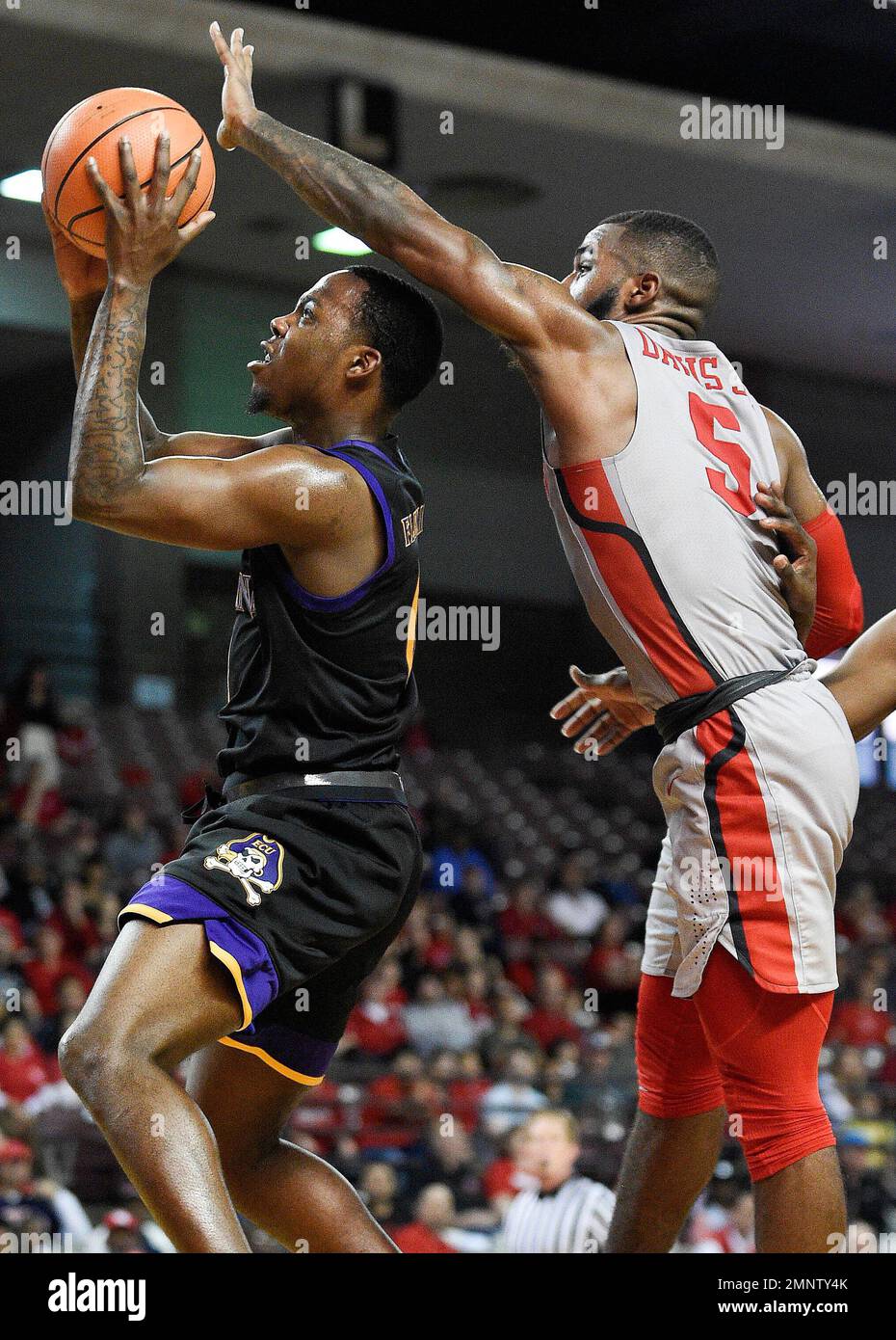 East Carolina guard Isaac Fleming, left, drives to the basket as ...