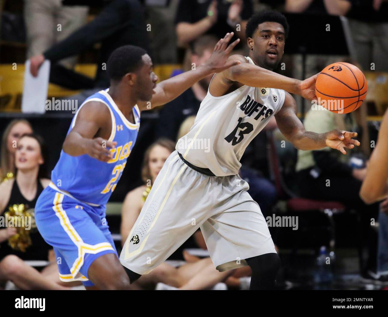 Colorado guard Namon Wright, right, looks to pass the ball as UCLA ...