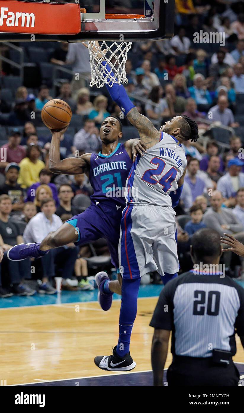 Charlotte Hornets' Treveon Graham (21) pushes his way past Detroit ...