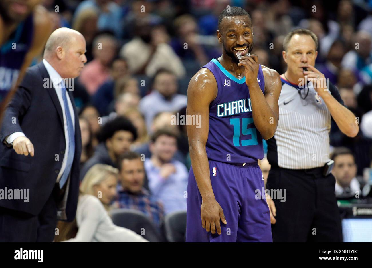 Charlotte Hornets' Kemba Walker (15) chuckles as he hears his head ...