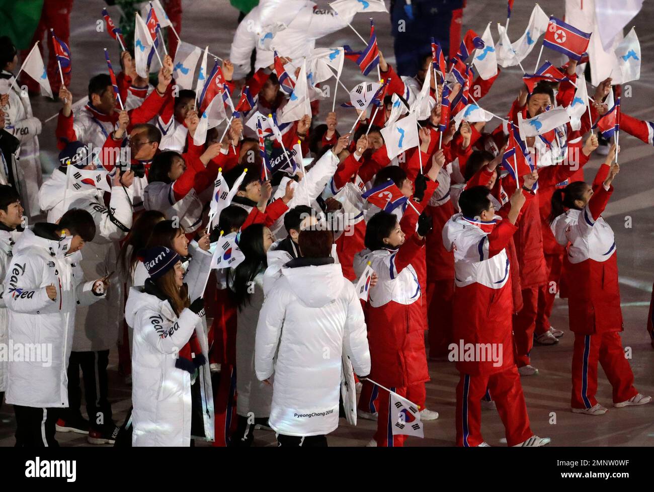 North Korean, in red, and South Korean athletes march into the stadium ...