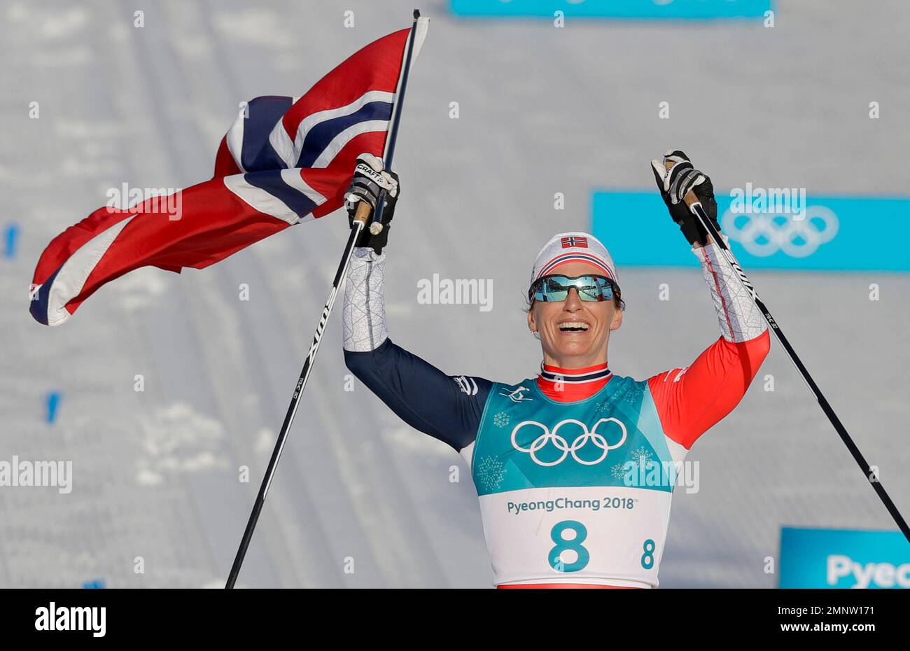 Marit Bjoergen, of Norway, celebrates after winning the gold medal in ...