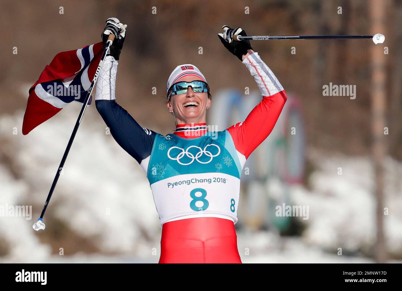 Marit Bjoergen, of Norway, celebrates after winning the gold medal in ...