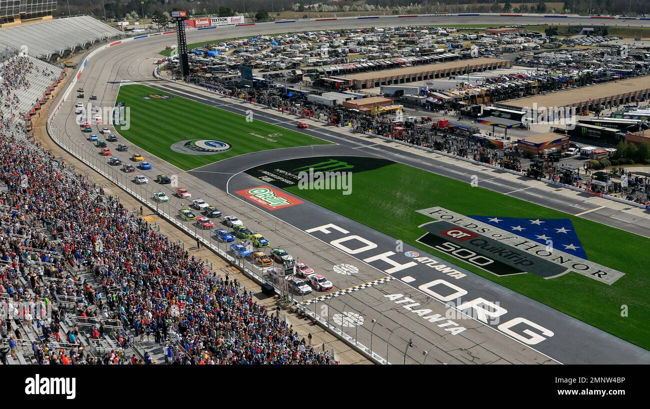 Drivers cross the start finish line the start of the NSCAR Xfinity ...