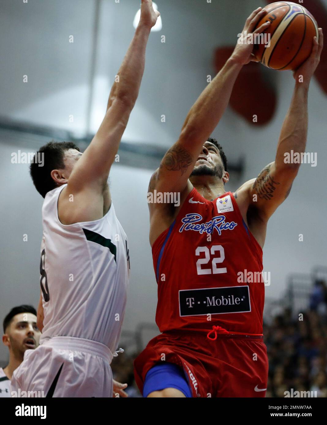 Puerto Rico's Emmanuel Andujar puts up a shot against Mexico's Francisco Cruz during their FIBA ...