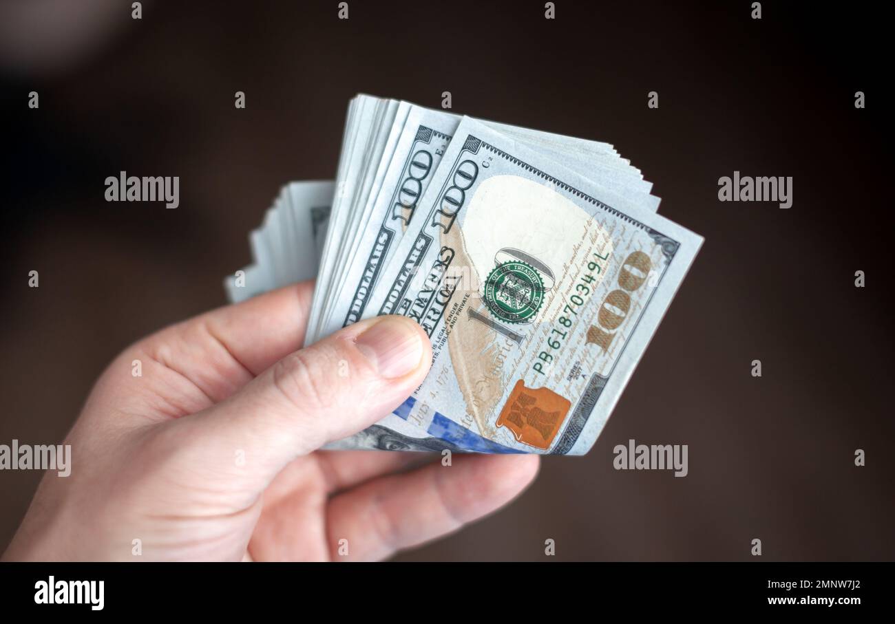 Male hand counting us currency hi-res stock photography and images - Alamy