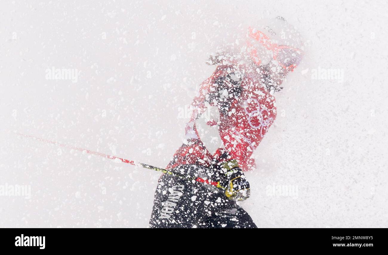 Brittany Phelan of Canada sprays snow as she crosses the finish line in ...