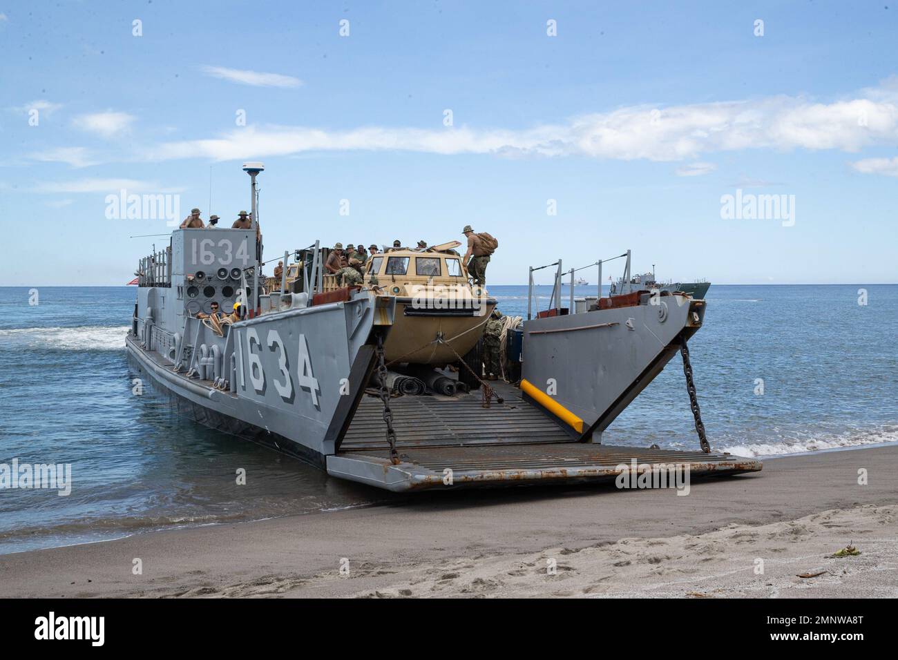 U.S. Navy Sailors with Naval Beach Unit Seven park a landing craft, utility during a rehearsal ...