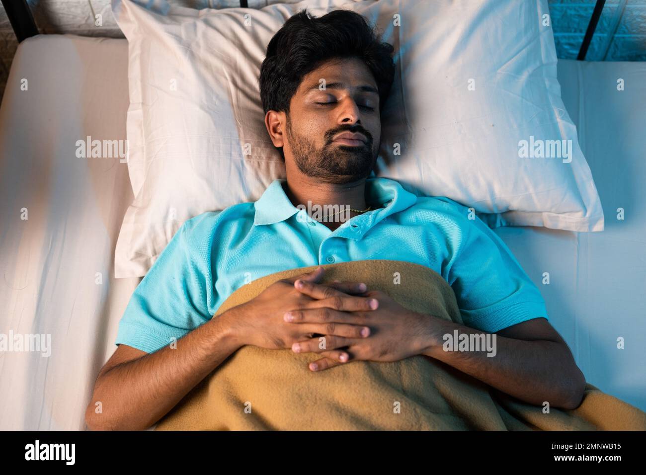 top view vertical shot of peacful young man sleeping during night ...