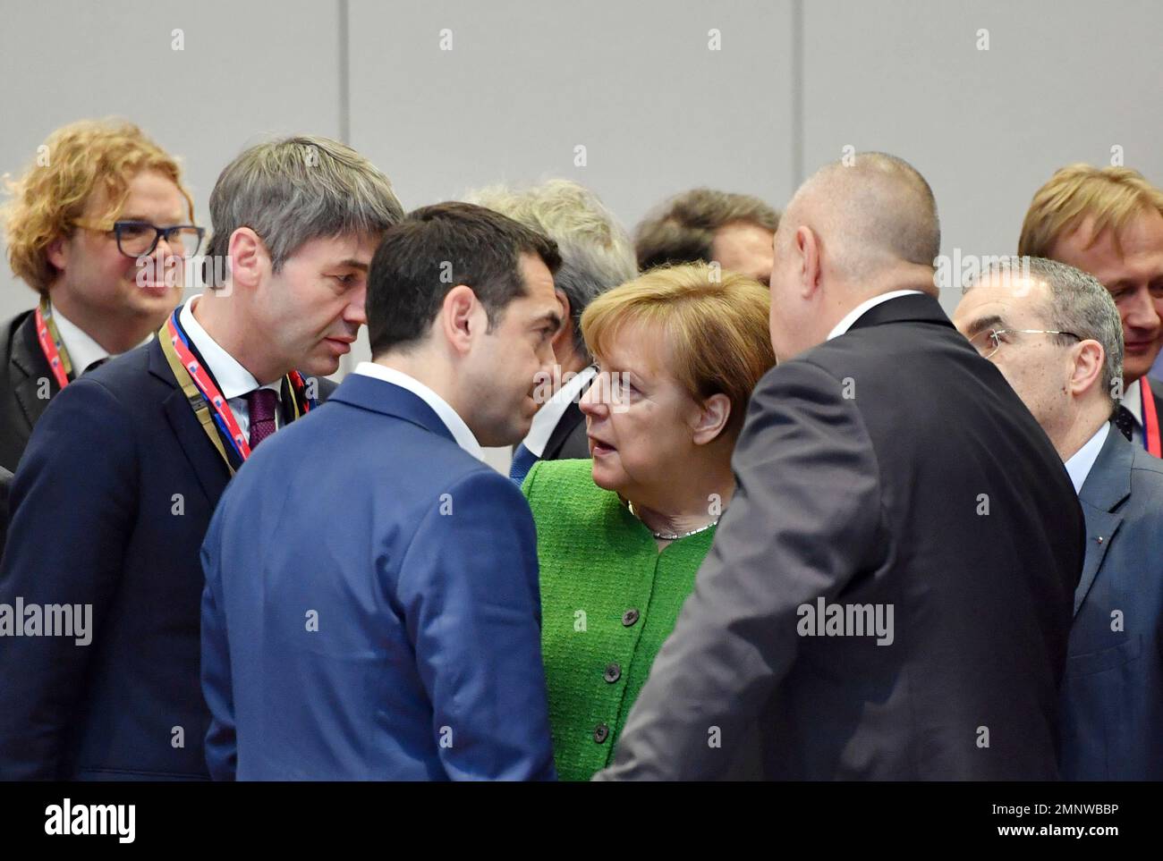 German Chancellor Angela Merkel, center, speaks with Greek Prime ...