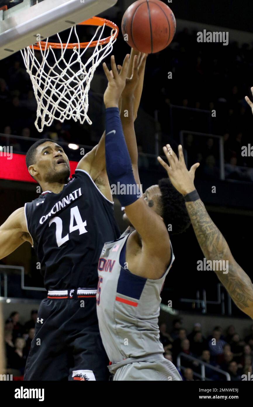 Cincinnati's Kyle Washington (24) blocks a shot by Connecticut's Josh ...