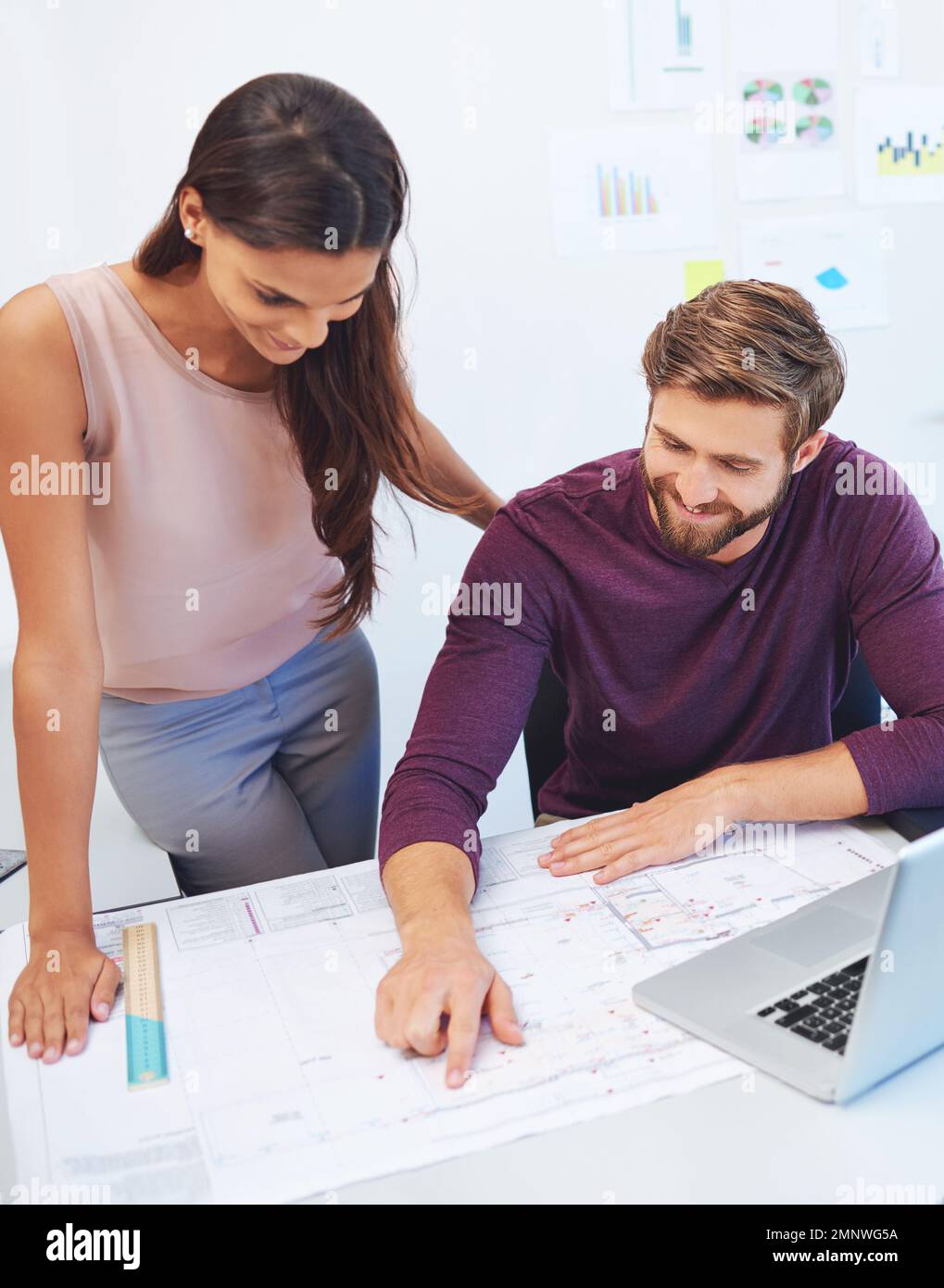 Two business people looking at plans hi-res stock photography and ...