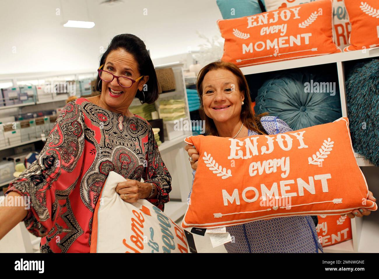Clients pose for photos while shopping at Marshalls during the grand ...