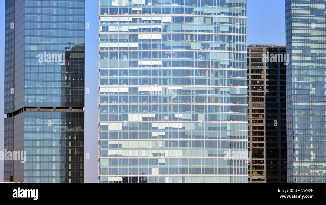 Abstract closeup of the glass-clad facade of a modern building covered ...