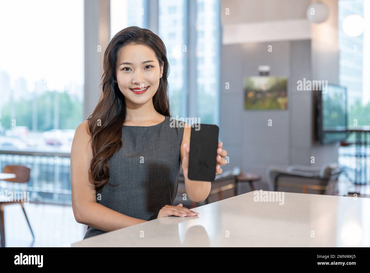 The use of mobile phones young business woman Stock Photo - Alamy