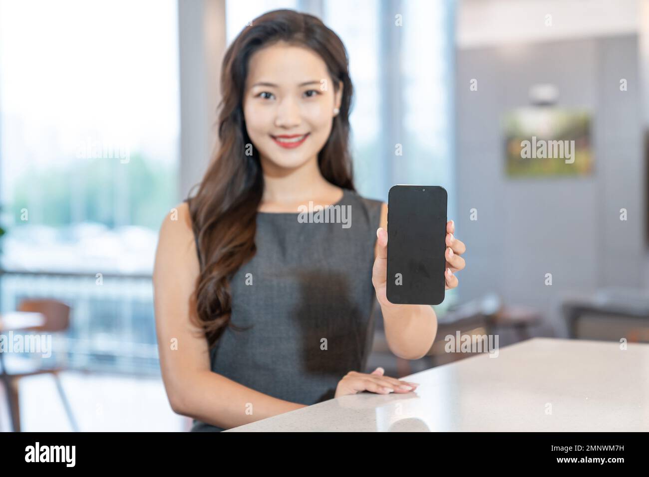 The use of mobile phones young business woman Stock Photo - Alamy