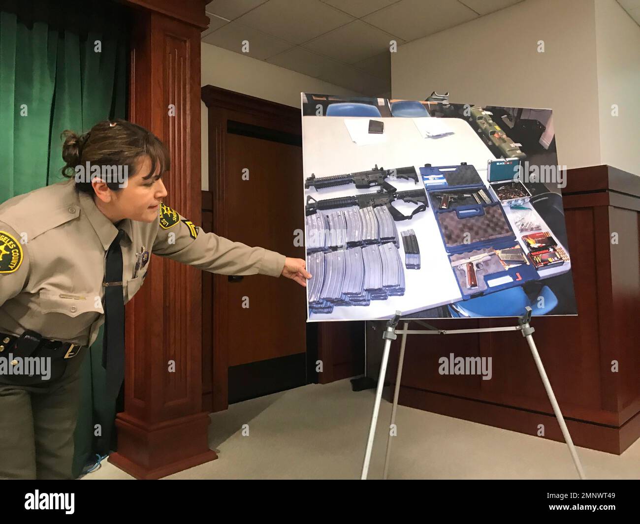 Deputy Lisa Jansen Displays Photos Of Weapons And Ammo At A News