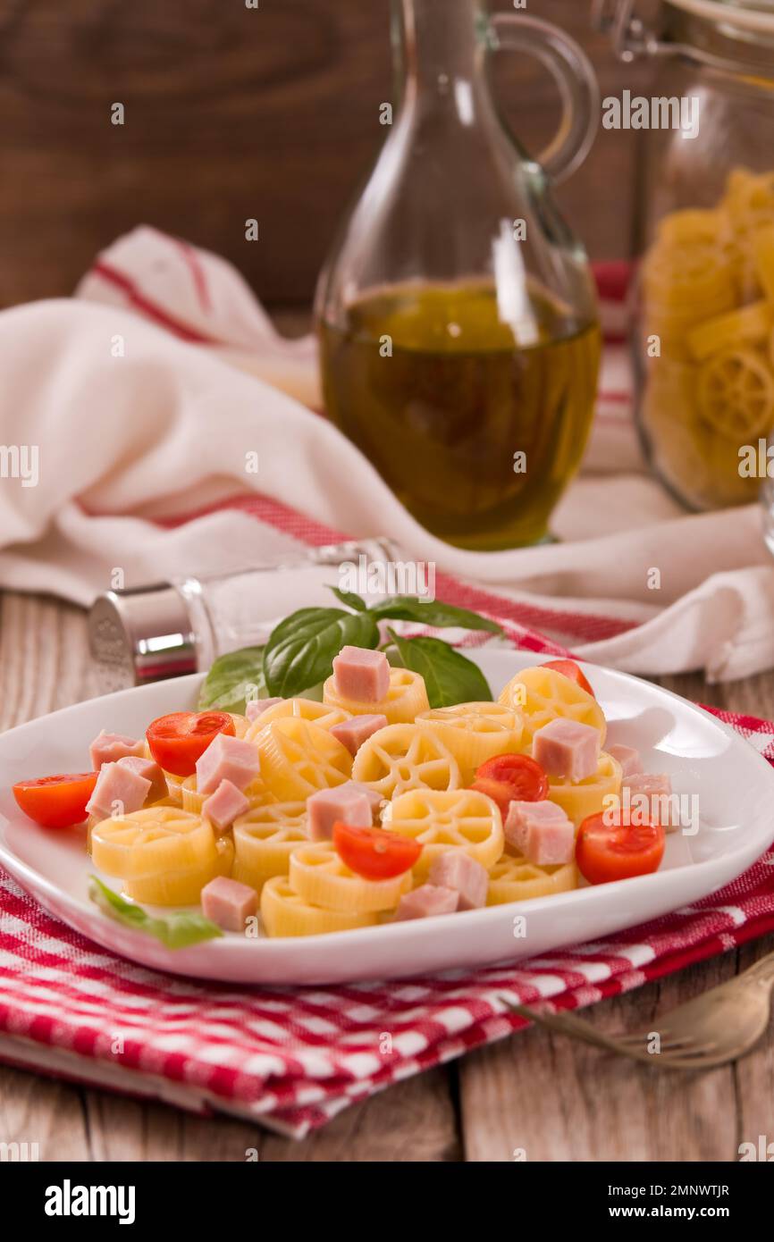 Ruote pasta with tomato and ham Stock Photo - Alamy