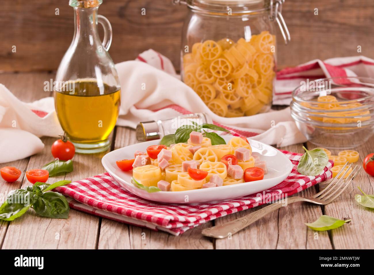 Ruote pasta with tomato and ham Stock Photo - Alamy
