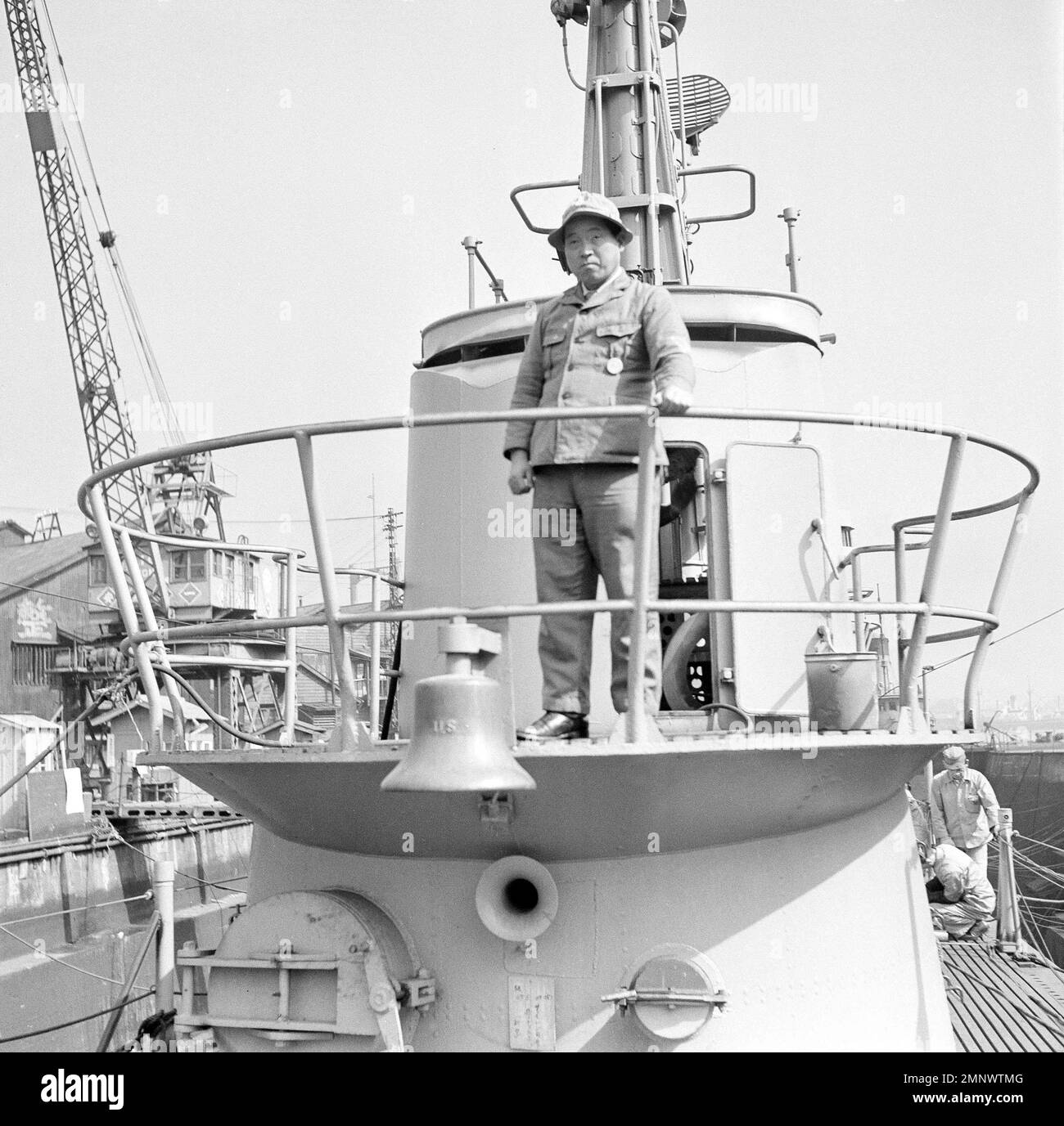 Commander Iko Hashimoto stands of the bridge of the former American ...