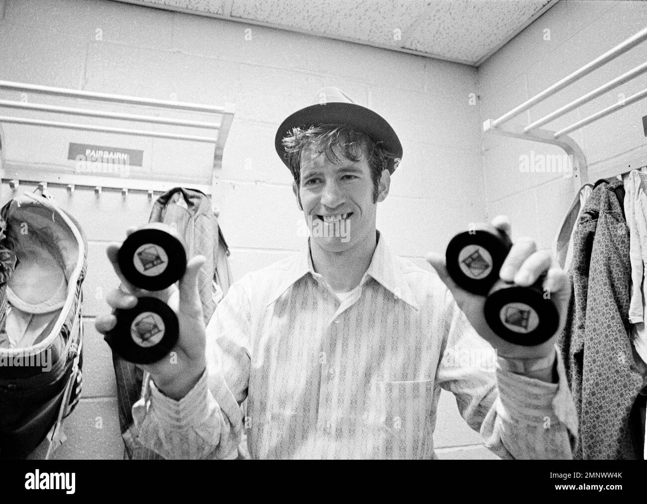 New York Rangers' Jean Ratelle is all smiles as he holds four pucks in ...