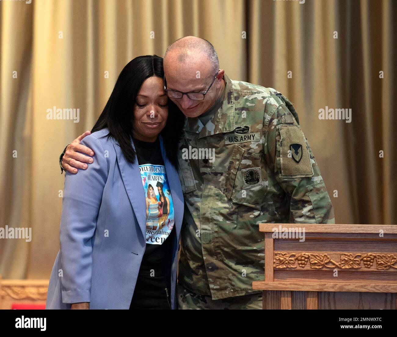 Chaplain (Lt. Col) Leonard R. Seims, deputy garrison chaplain, hugs ...