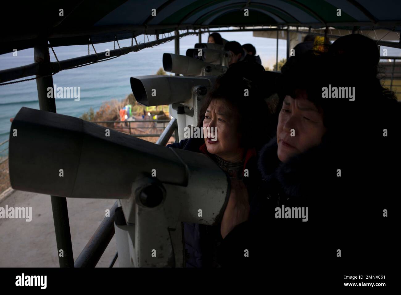 Visitors use binoculars to view North Korea from the Goseong ...