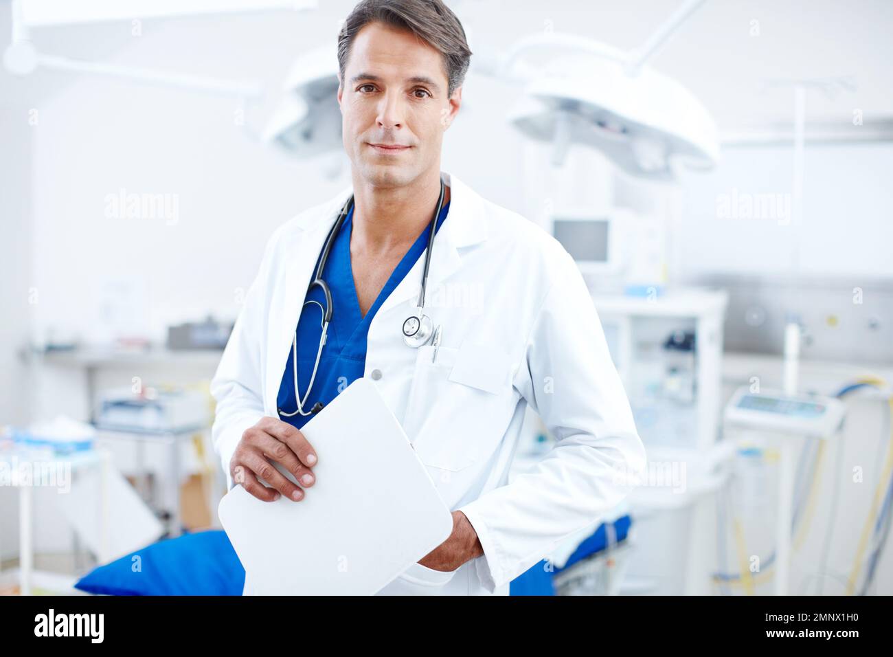 You have nothing to worry about. A confident male doctor standing in ...