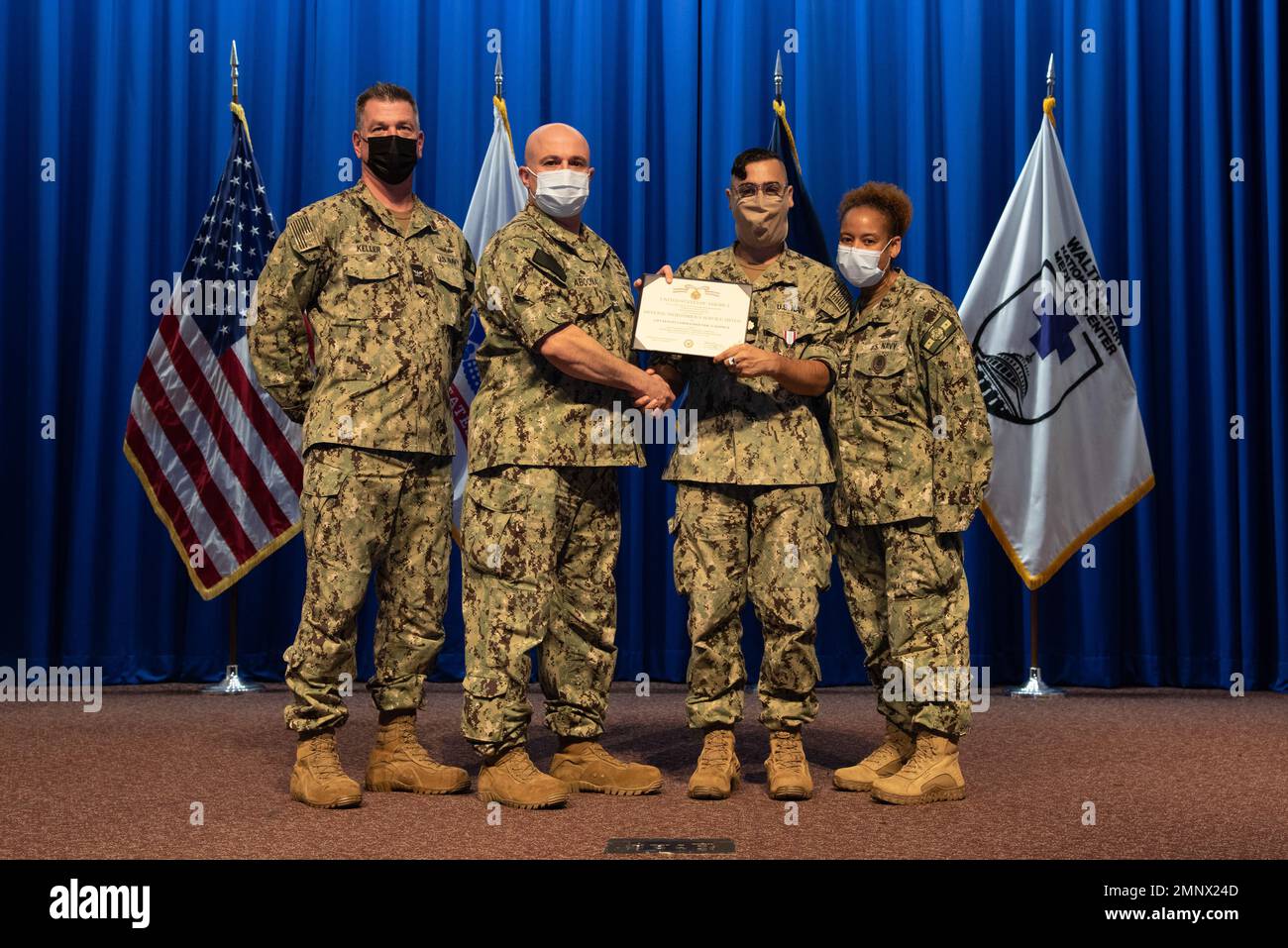 Lt. Cmdr. Eric Serpico, center right, poses for a group photo with Navy ...