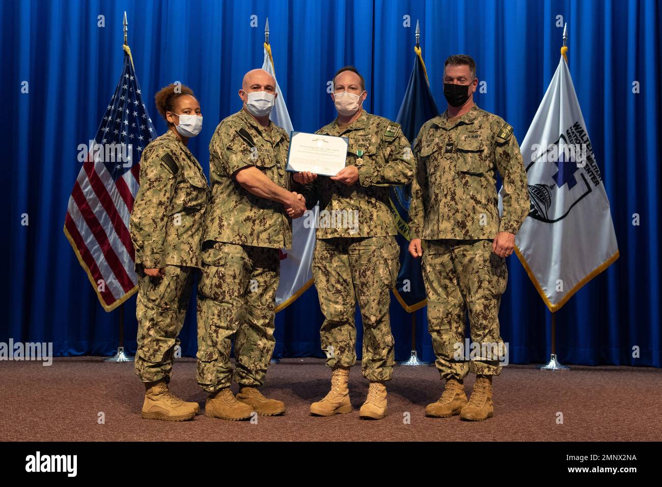 Cmdr. Thomas Ableman, center right, poses for a group photo with Navy ...