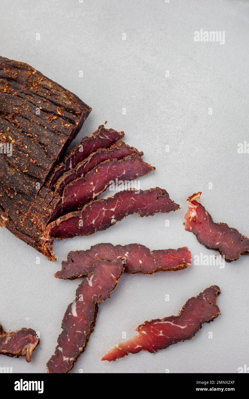 Freshly cut South African biltong on light background with selective ...