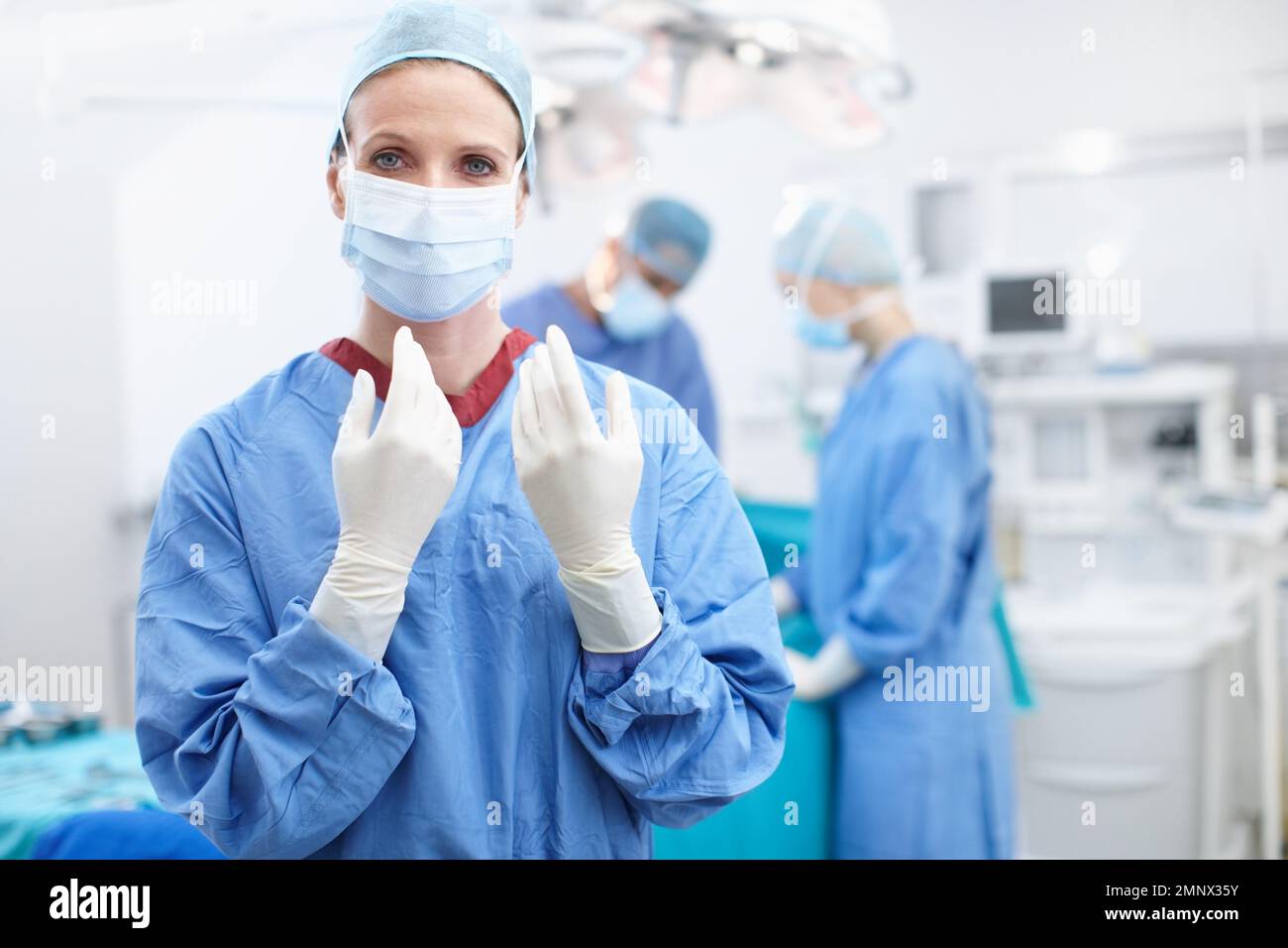 A matter of life and death. Portrait of a female surgeon wearing gloves ...