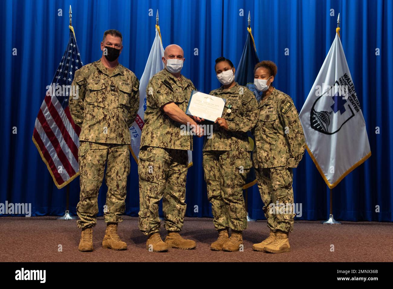 Chief Navy Counselor Rachel Oyegoke, center right, poses for a group ...