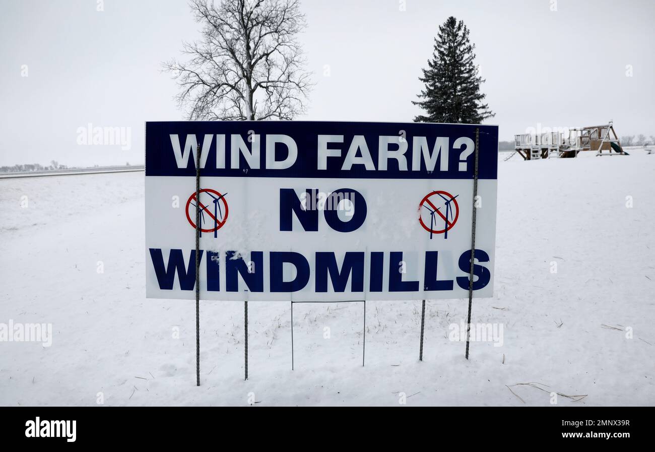 An anti wind turbine sign stands in the front yard of a farmhouse ...