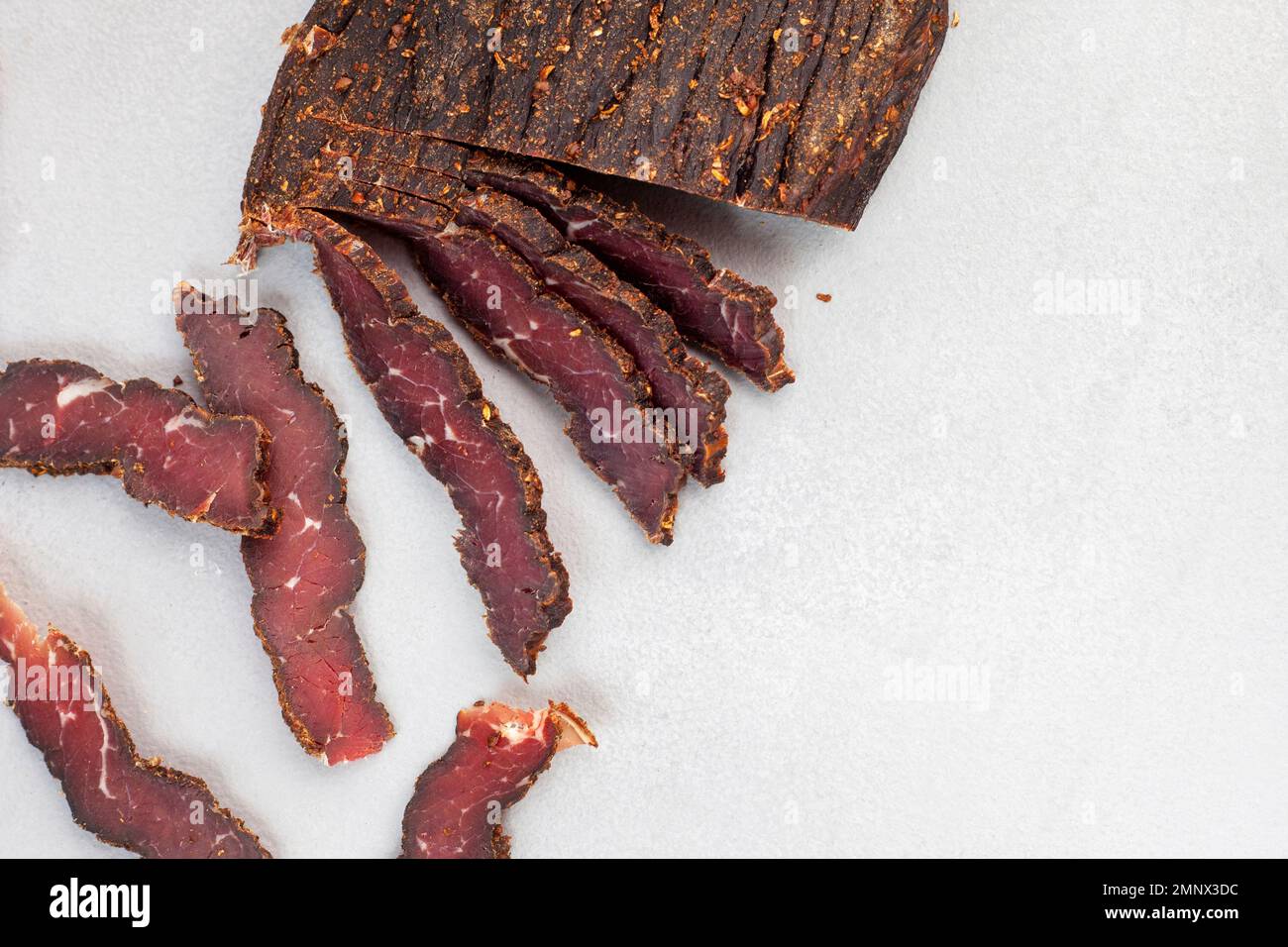 Freshly cut South African biltong on light background with selective ...