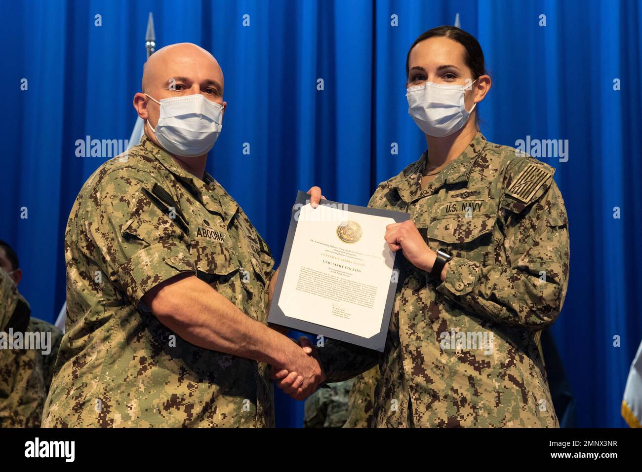 Lt. j.g. Mary Collins receives a Letter of Appreciation from Capt ...