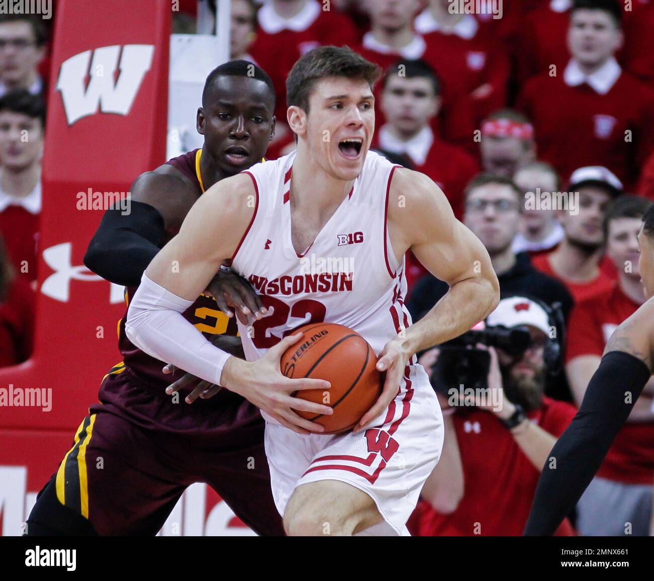 Minnesota's Bakary Konate (21) reaches in on Wisconsin's Ethan Happ (22 ...