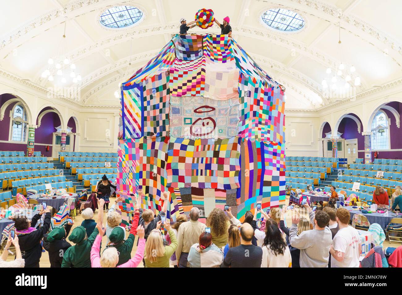 EDITORIAL USE ONLY People watch as workers place a giant bobble on top ...