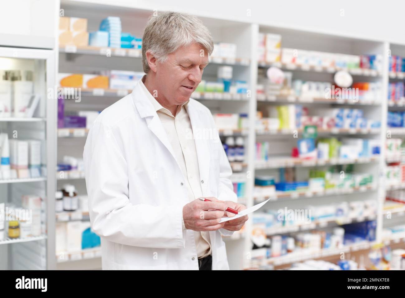 Pharmacist checking prescription. Portrait of handsome pharmacist ...