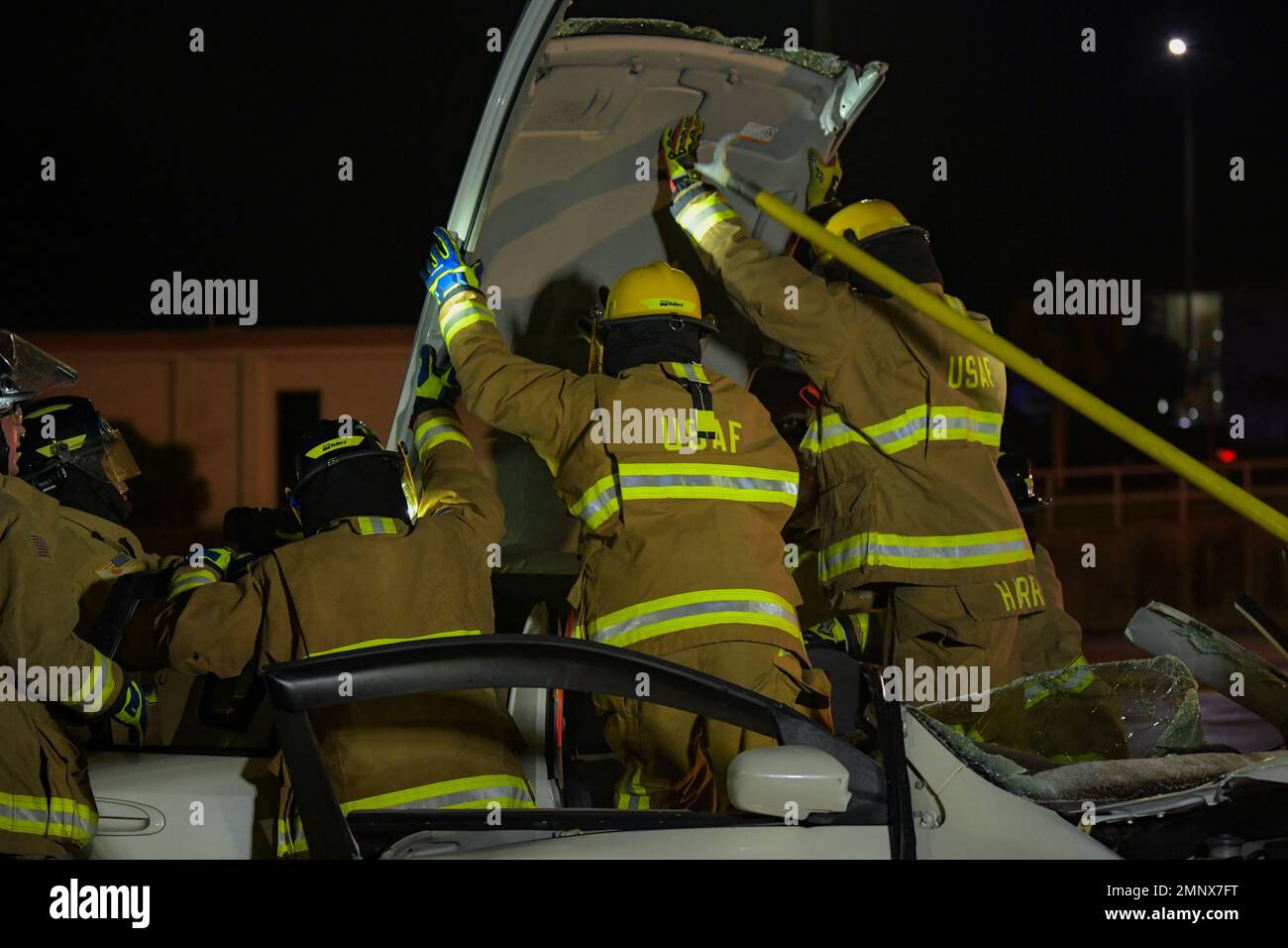 Firefighters from the 18th Civil Engineer Squadron remove a car roof ...