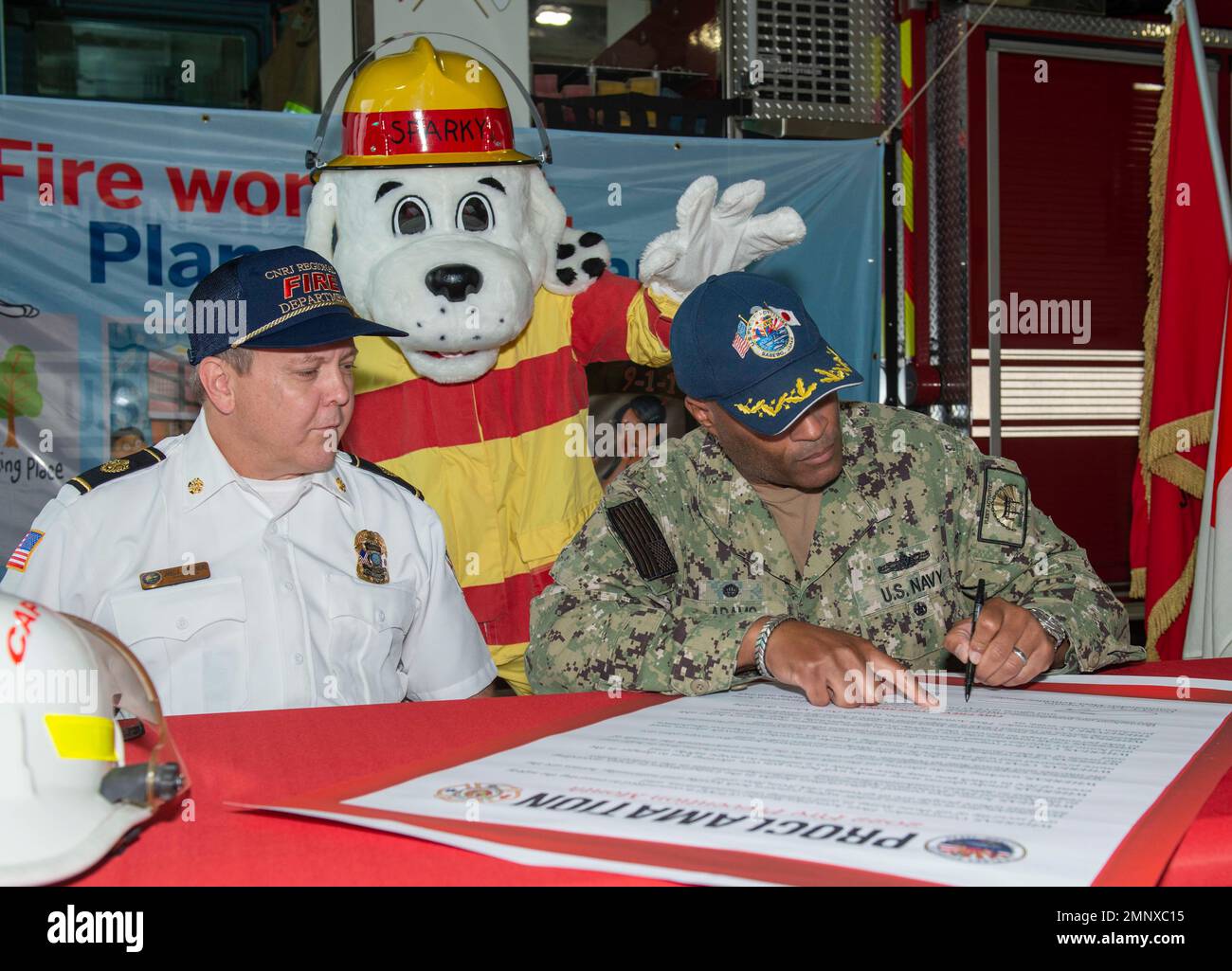 Capt. David Adams, Commander, Fleet Activities Sasebo (CFAS), signs the ...