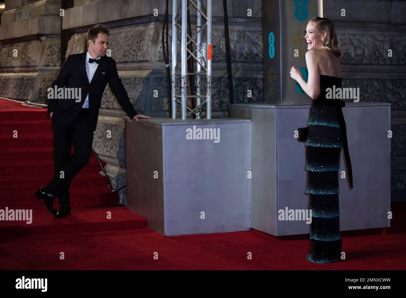 Actor Sam Rockwell, left, watches partner Leslie Bibb as she poses for ...
