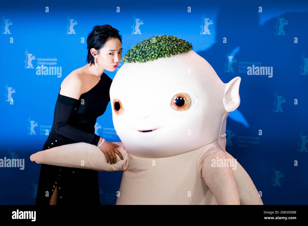 Actress Baihe Bai, left, kisses a person dressed as the character Wuba ...