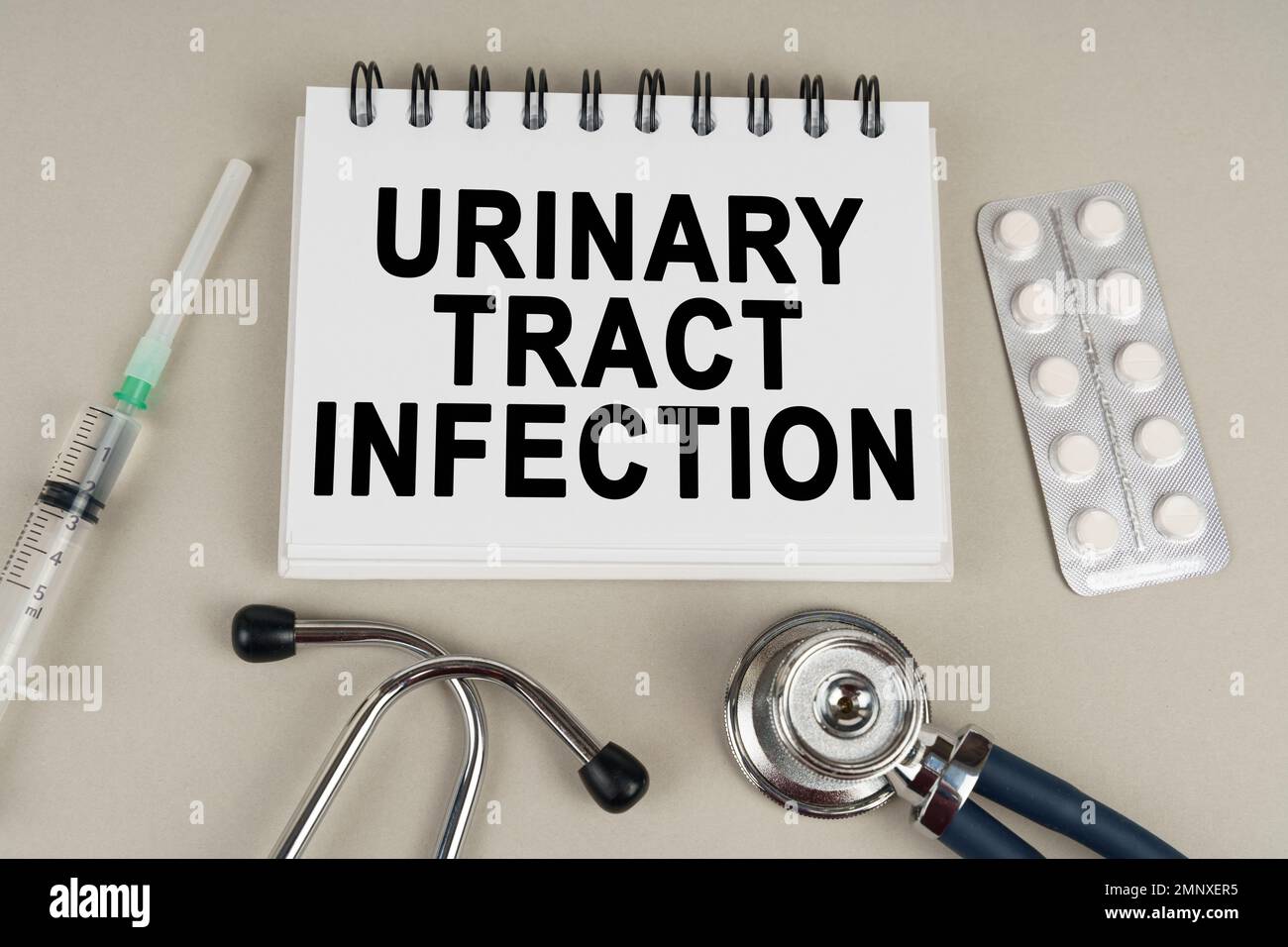 Medical concept. On a gray surface, a syringe, a thermometer, a ...