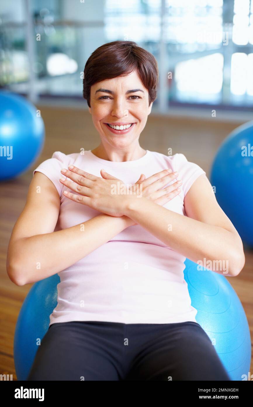 Woman smiling during workout. Portrait of fit woman smiling while ...